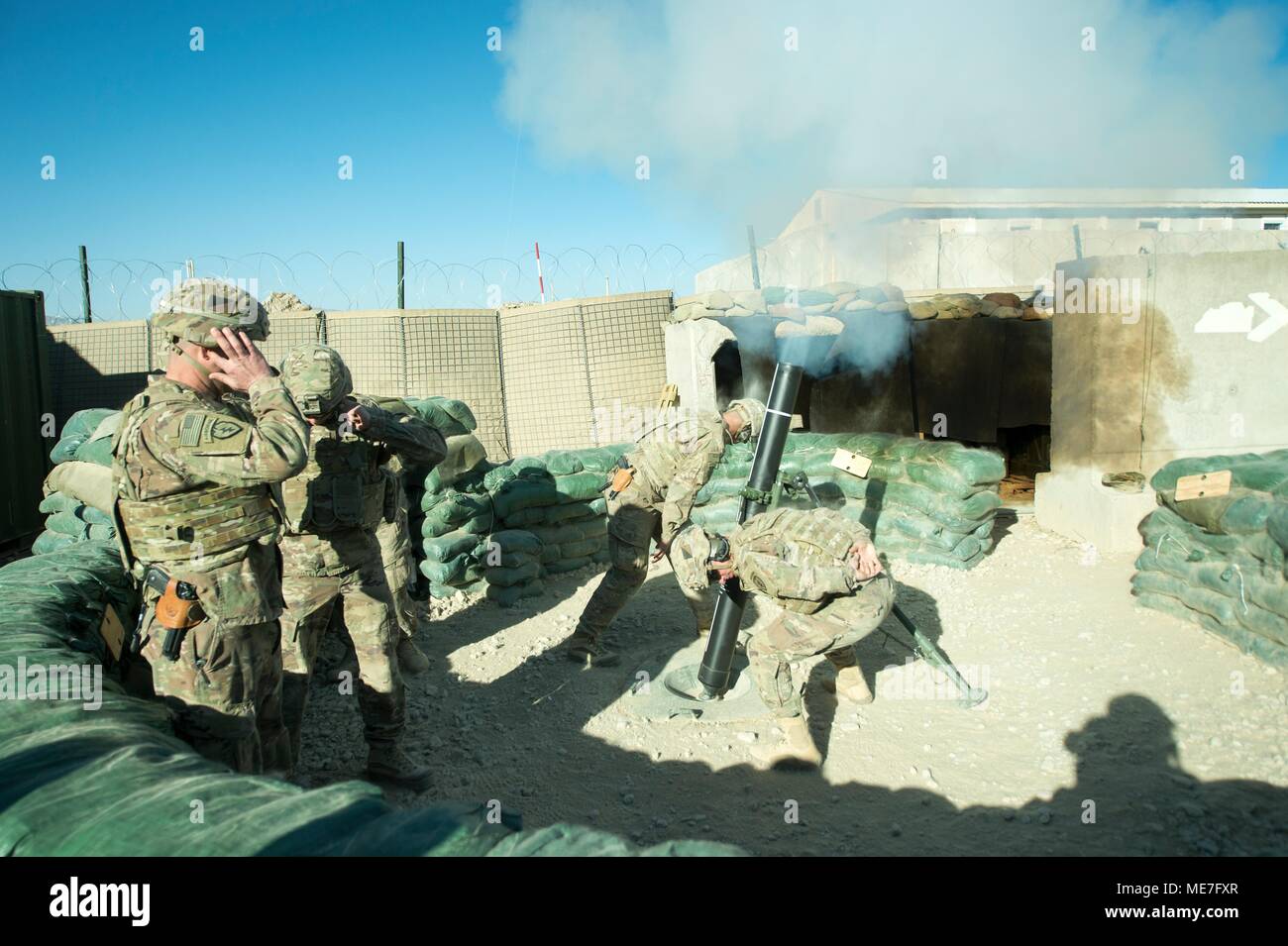 U.S. soldiers perform a mortar demonstration for USO entertainers ...