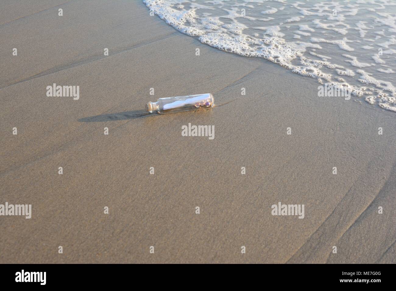 Message in a Bottle Washed Up on the Shore Stock Photo - Alamy