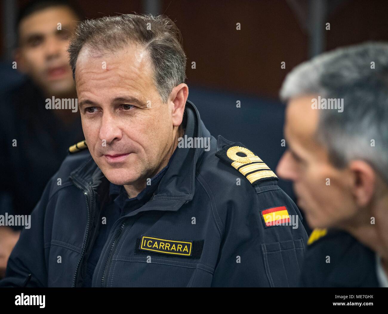 Spanish Navy Commanding Officer Isidro Carrara Navas listens to a ...
