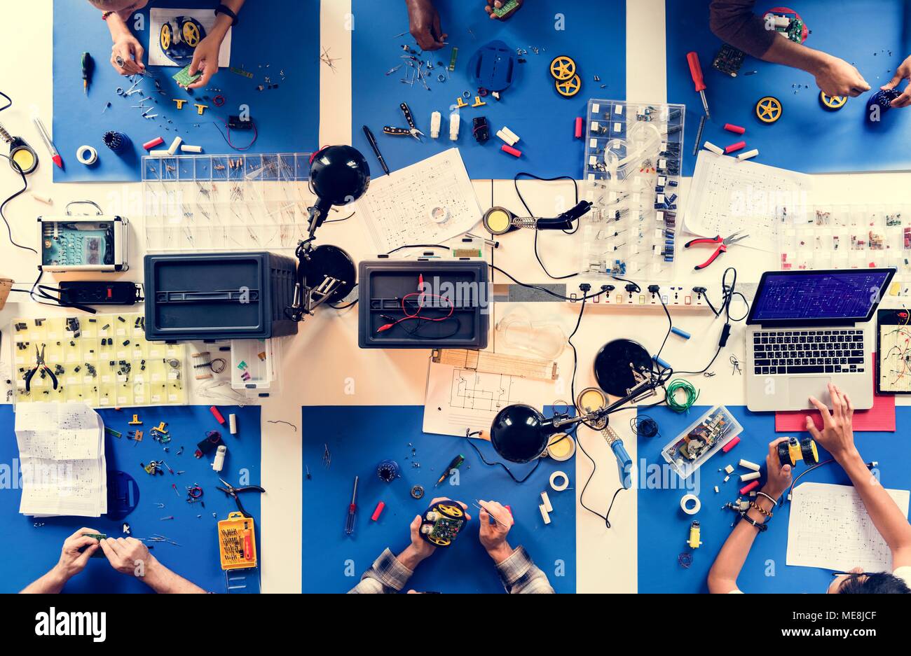 Aerial view of electronics technicians team working Stock Photo - Alamy