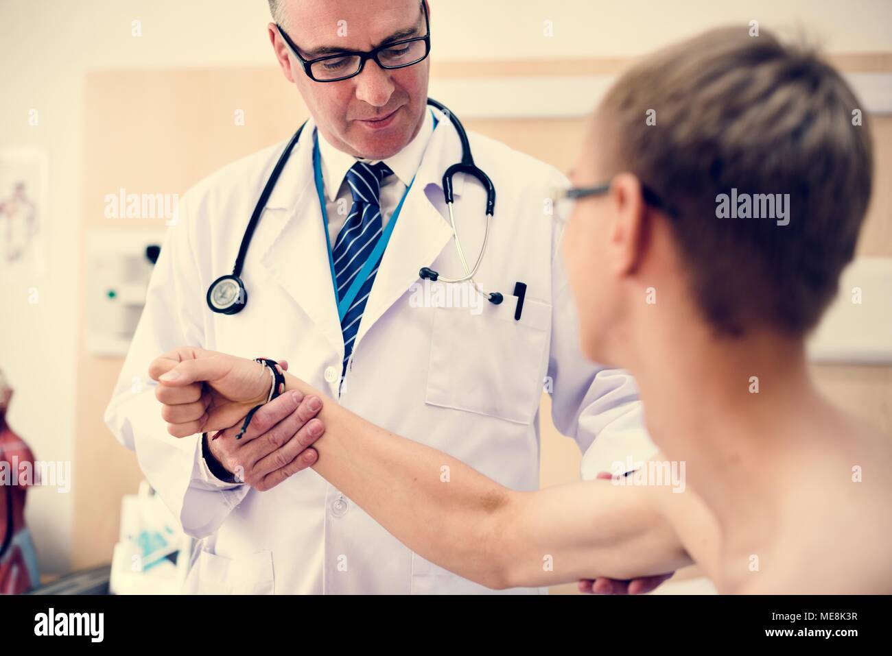 Doctor checking up a patient Stock Photo - Alamy