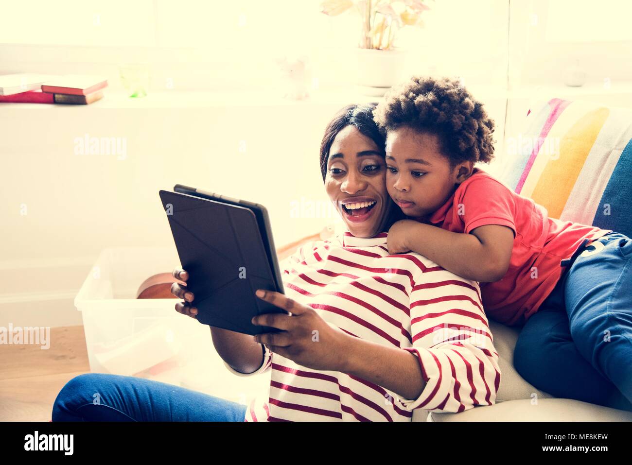 Mom and son using tablet together Stock Photo - Alamy