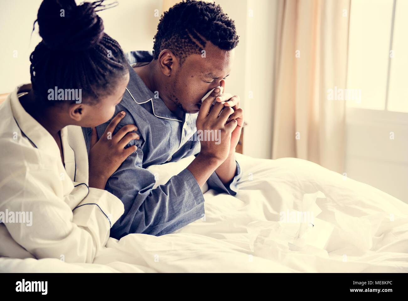 A sick person being taken cared of by his girlfriend Stock Photo - Alamy