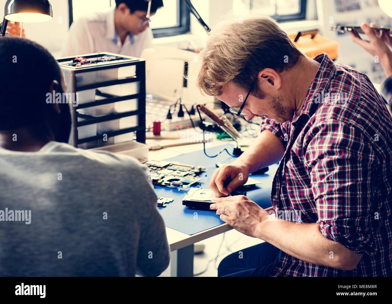 Technicians working on computer hard disk Stock Photo - Alamy