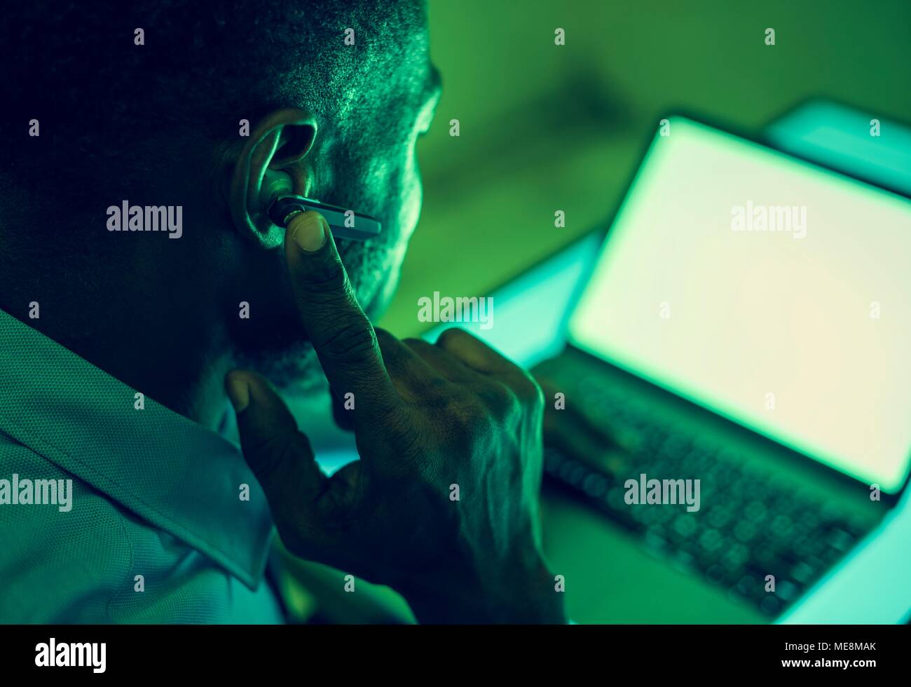 A man using bluetooth earphone device to communicate Stock Photo - Alamy