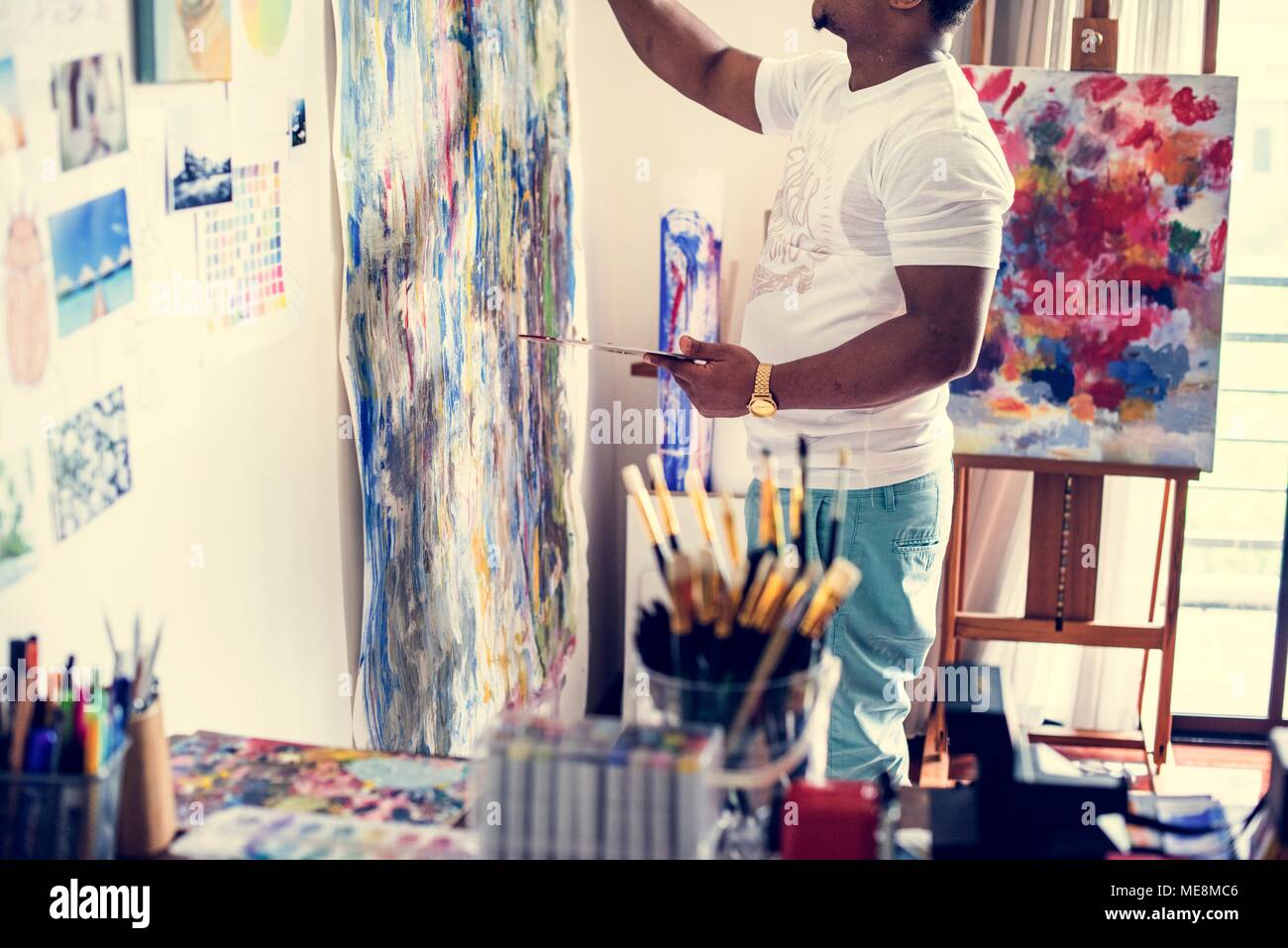 Black artist man doing his art work Stock Photo - Alamy