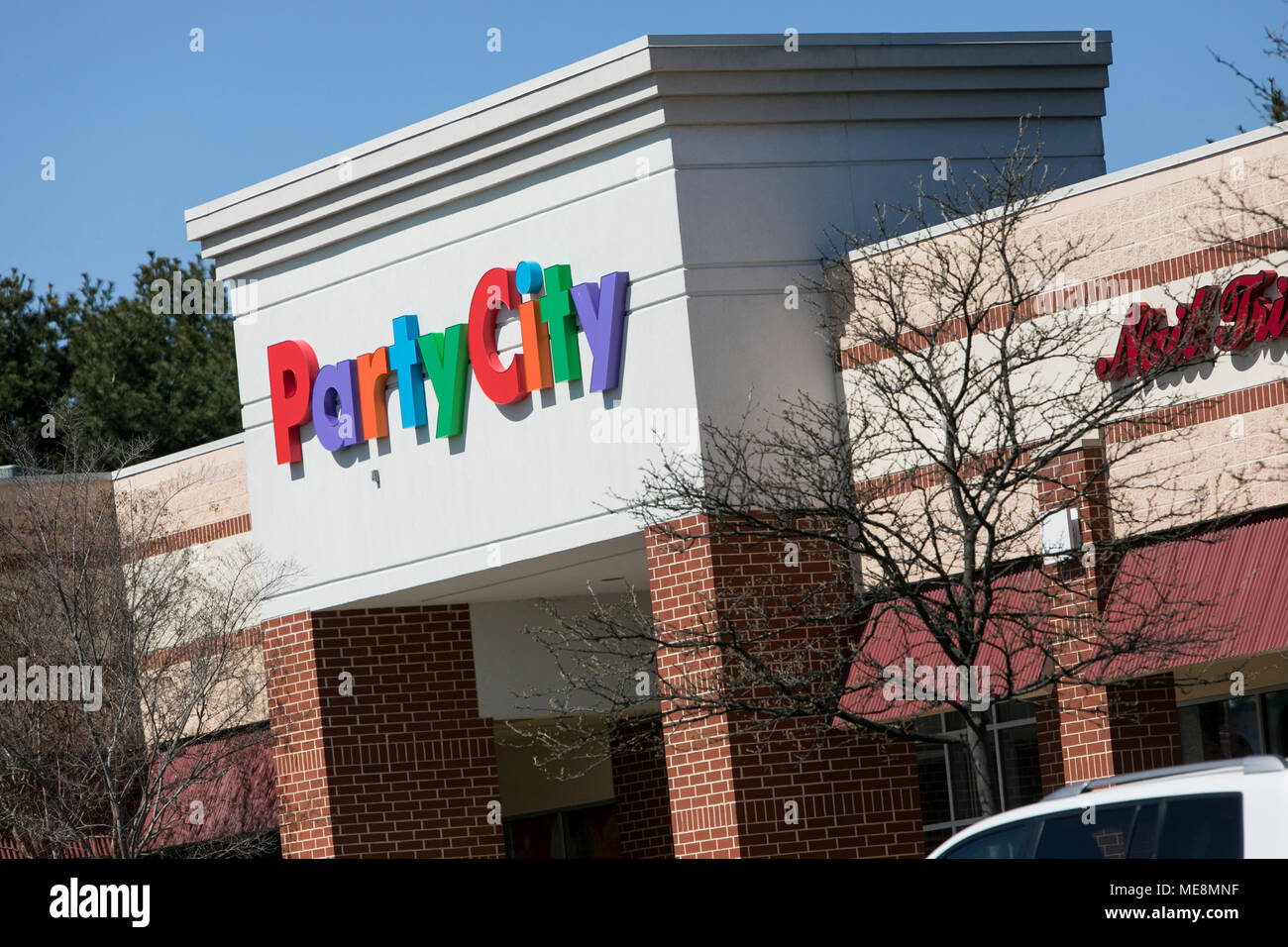 A logo sign outside of a Party City retail store location in Columbia ...