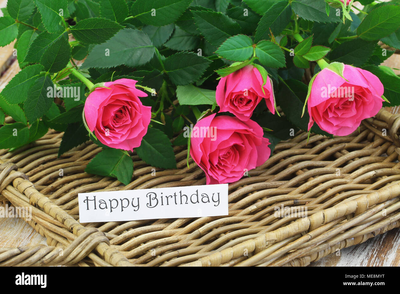 Happy Birthday card with pink wild roses on wicker surface Stock Photo ...