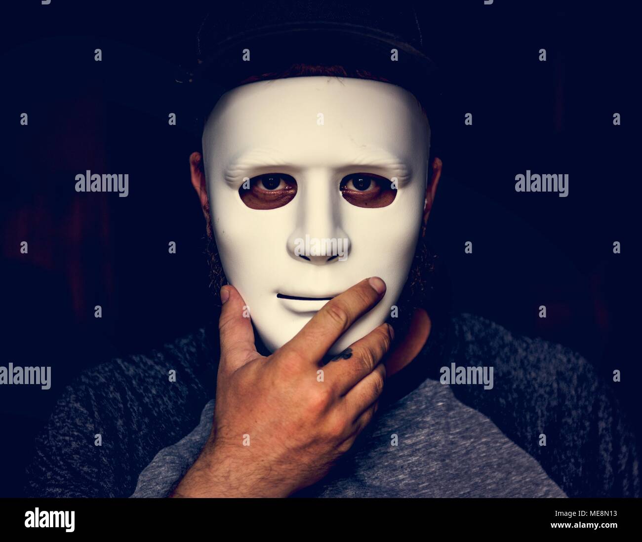 Hand holding mask on a face Stock Photo - Alamy