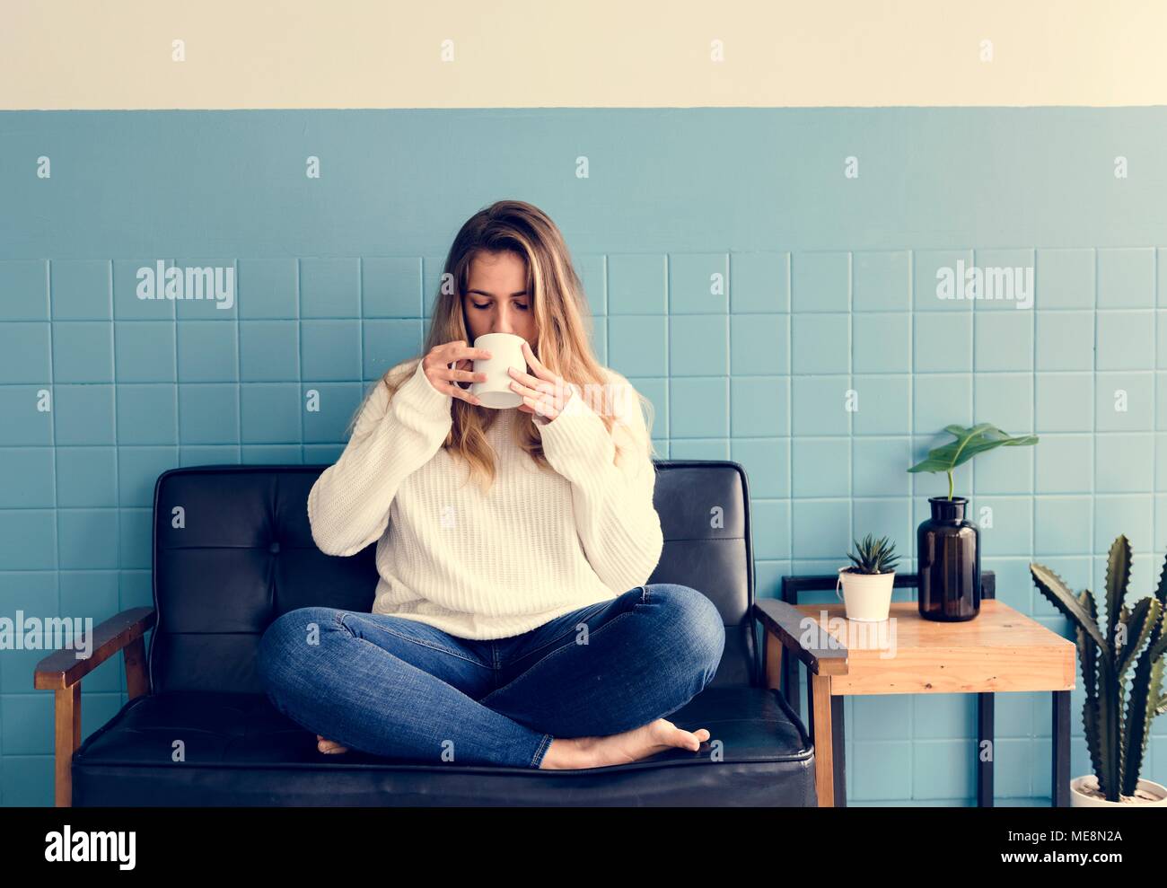 A Caucasian Woman Sitting and Drinking Coffee Stock Photo - Alamy