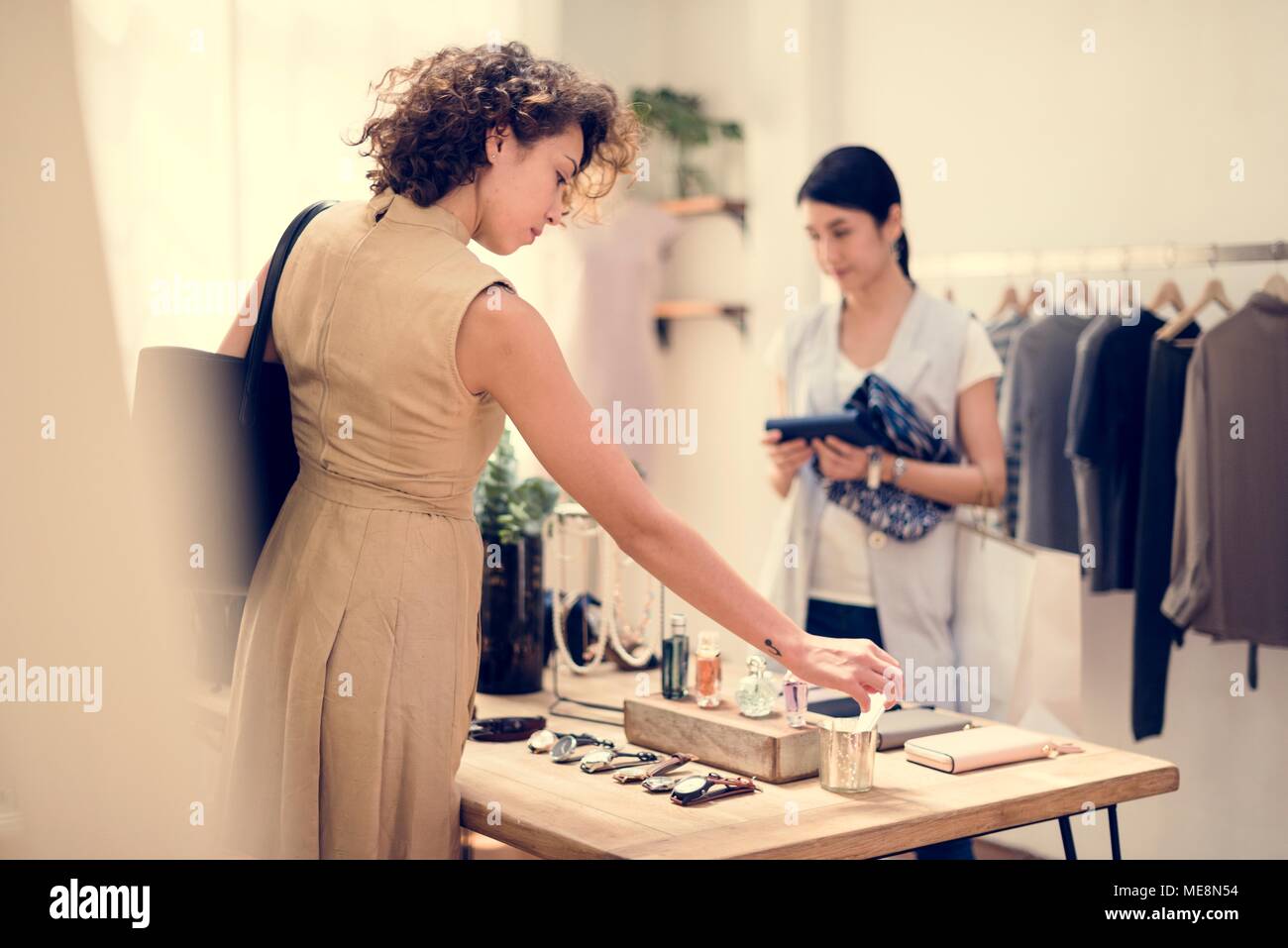 People checking out clothes Stock Photo - Alamy