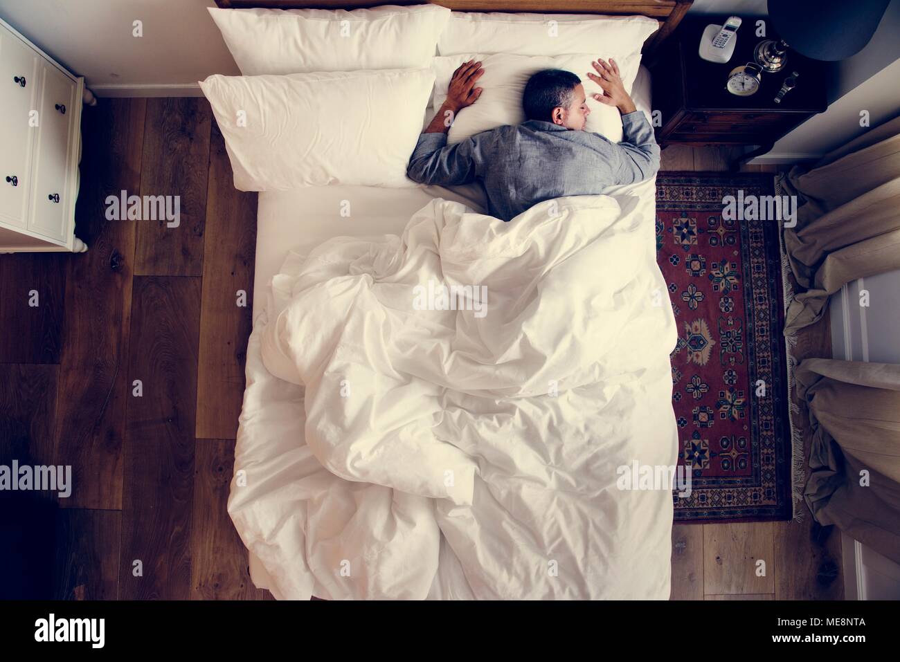 French man sleeping alone on bed Stock Photo - Alamy