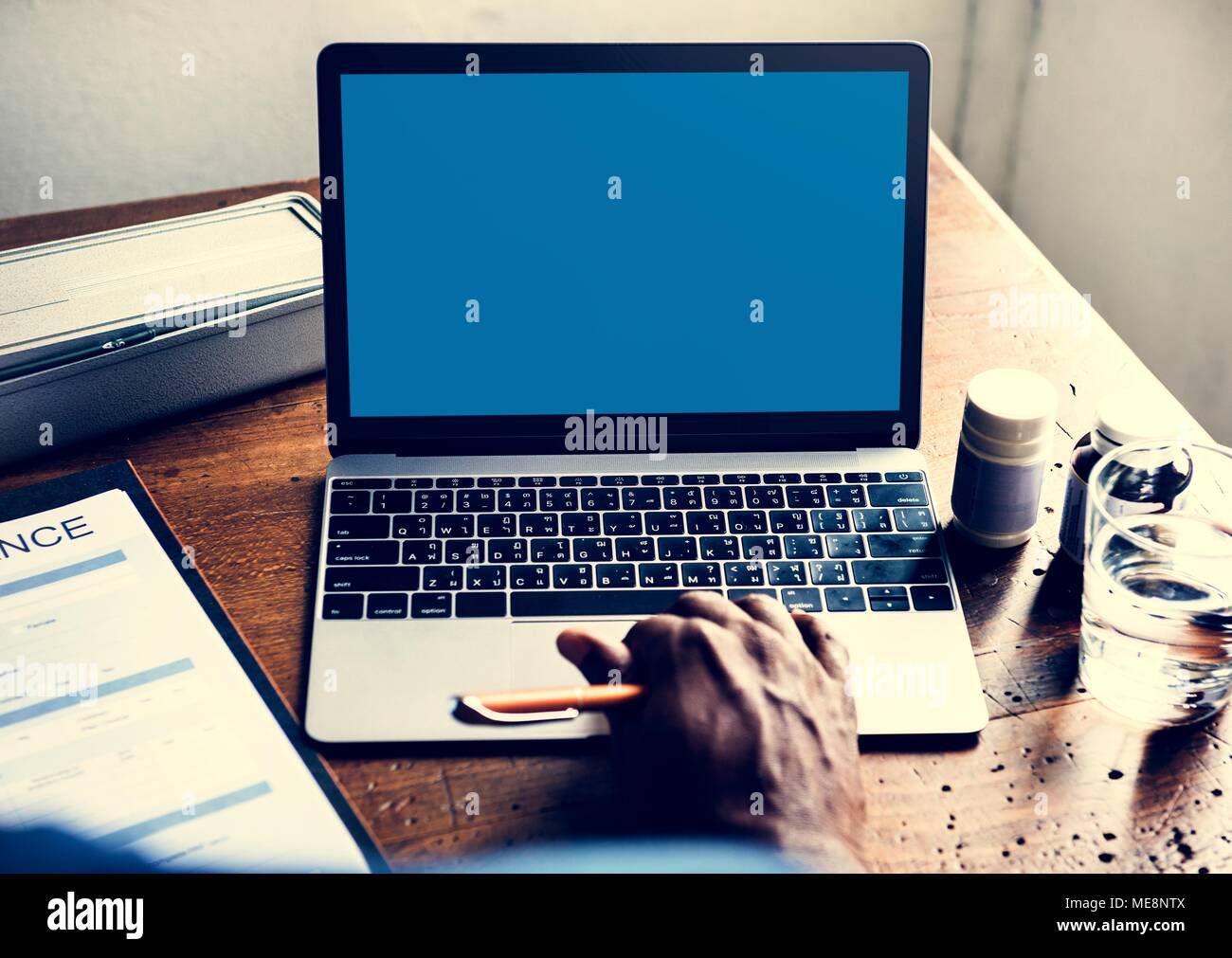Rear view of people using computer laptop showing empty blue screen ...