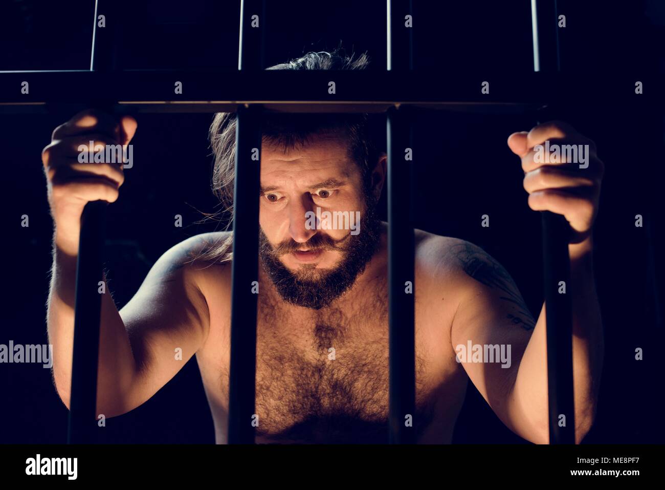 An angry man in a jail Stock Photo - Alamy
