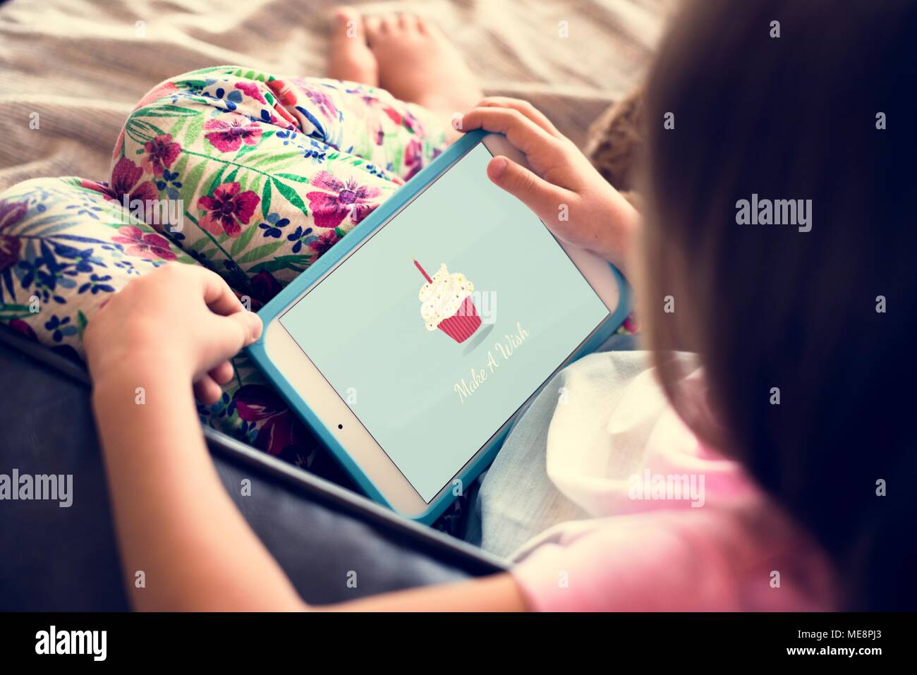 Young girl is using digital tablet Stock Photo - Alamy