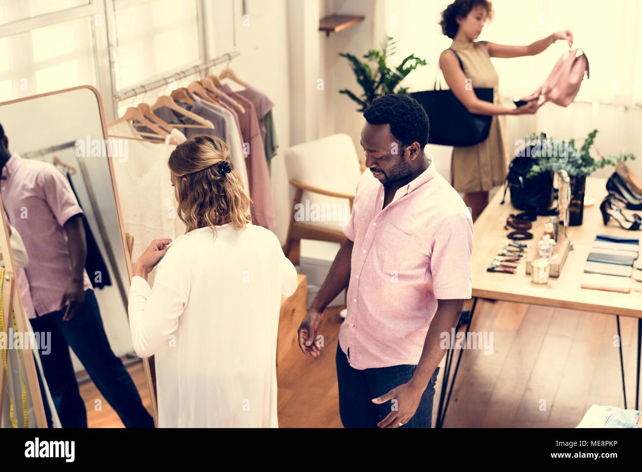 People checking out clothes Stock Photo - Alamy