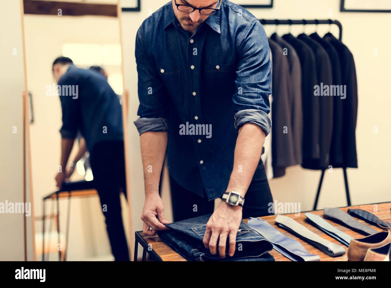 Man working in retail cloth shop Stock Photo - Alamy
