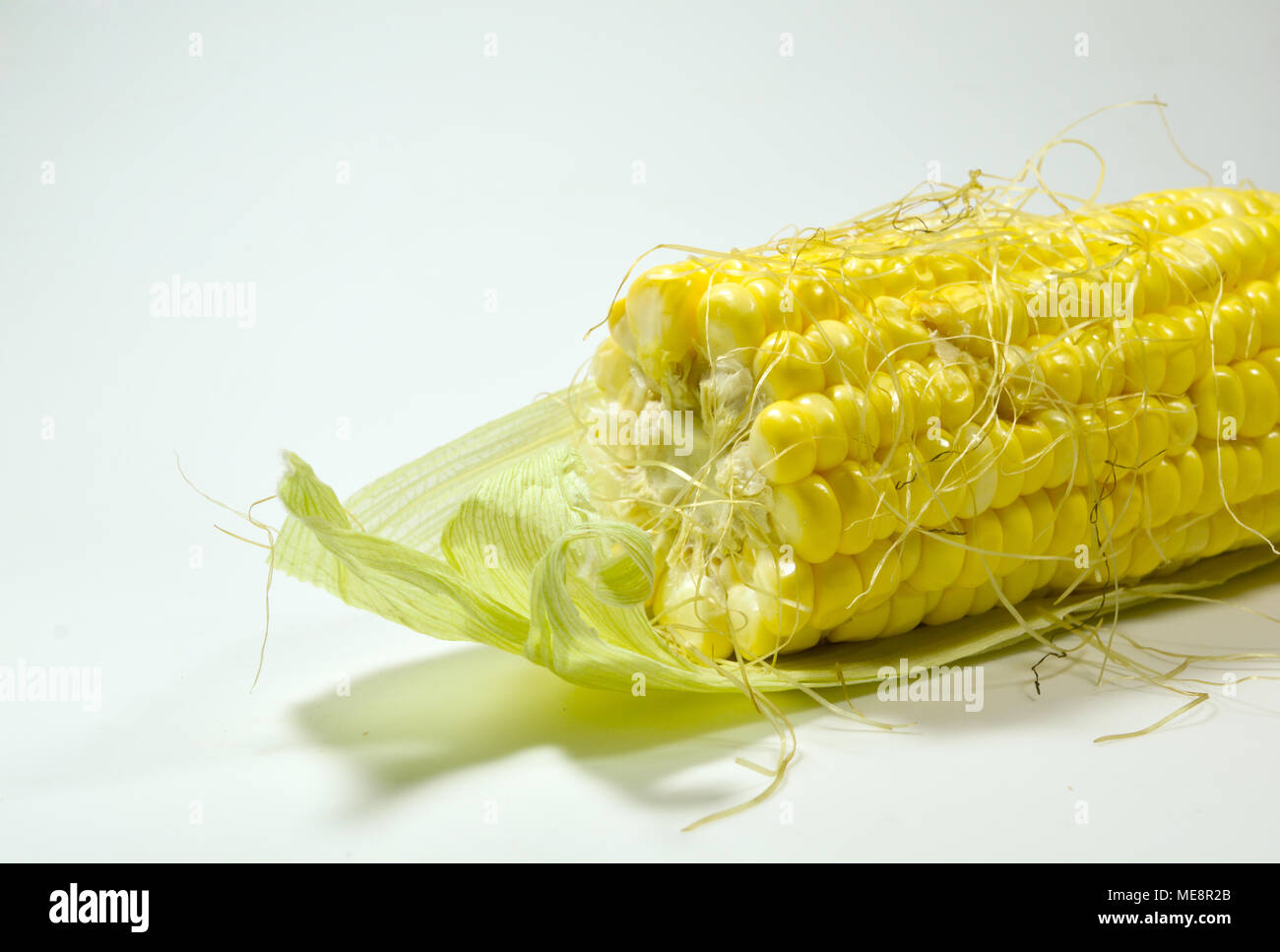 Corn cut into a piece with leaves surrond on white background Stock ...