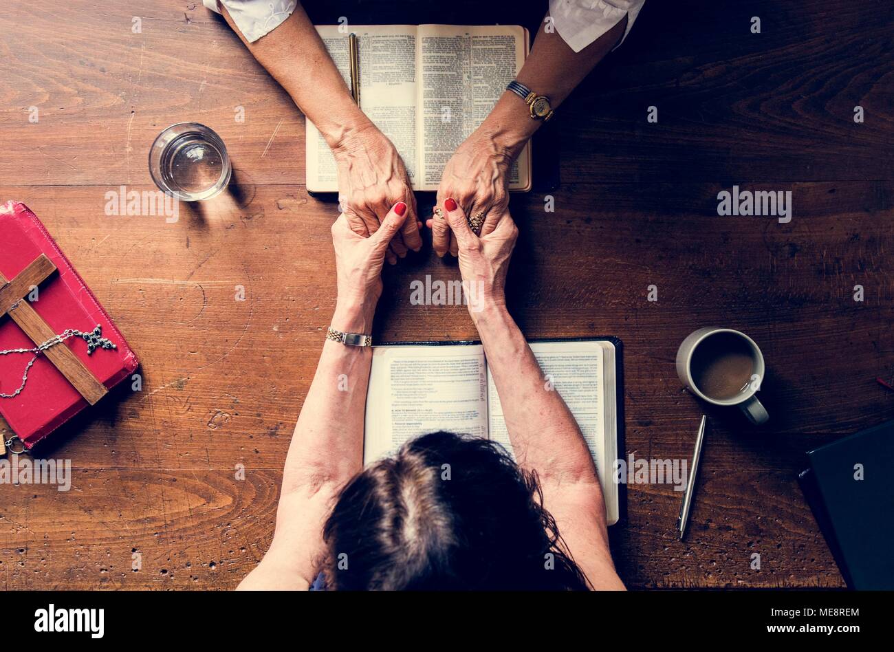 Christianity people praying reading bible Stock Photo - Alamy