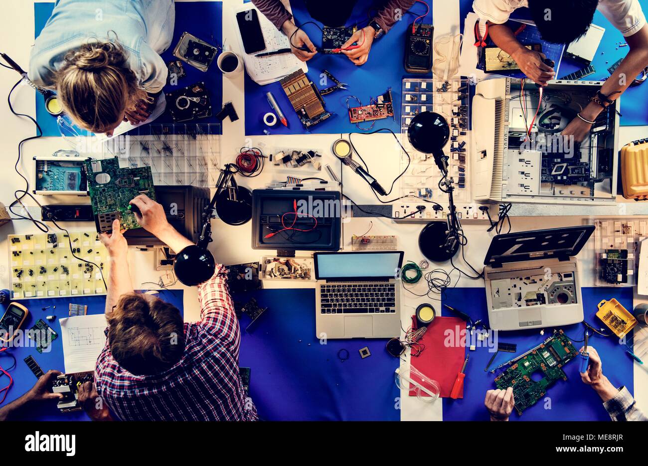 Aerial view of electronics technicians team working Stock Photo - Alamy