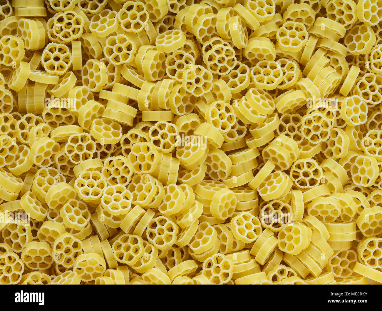 Raw ruote background of pasta, textured close-up view from the top ...
