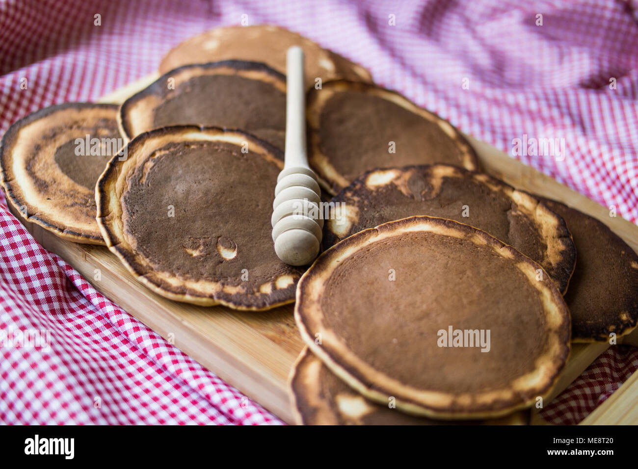 Stack of plain Pancakes on wooden surface Stock Photo - Alamy