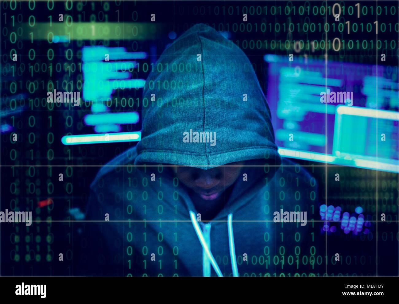 Hacker in a hoody with computer background Stock Photo - Alamy
