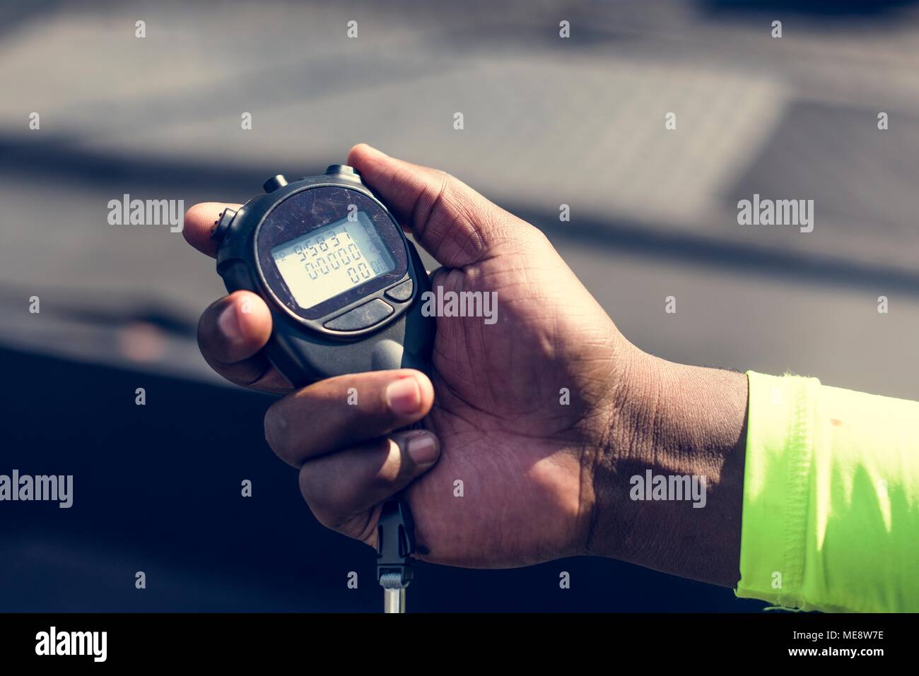 Closeup of hand holding stopwatch Stock Photo - Alamy