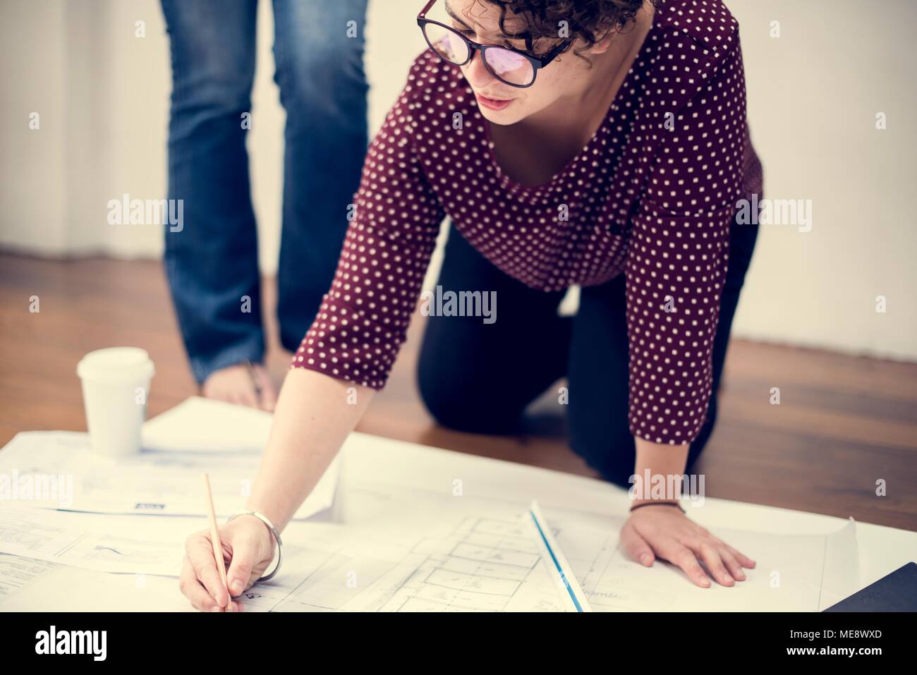 Woman working on drawing a plan Stock Photo - Alamy
