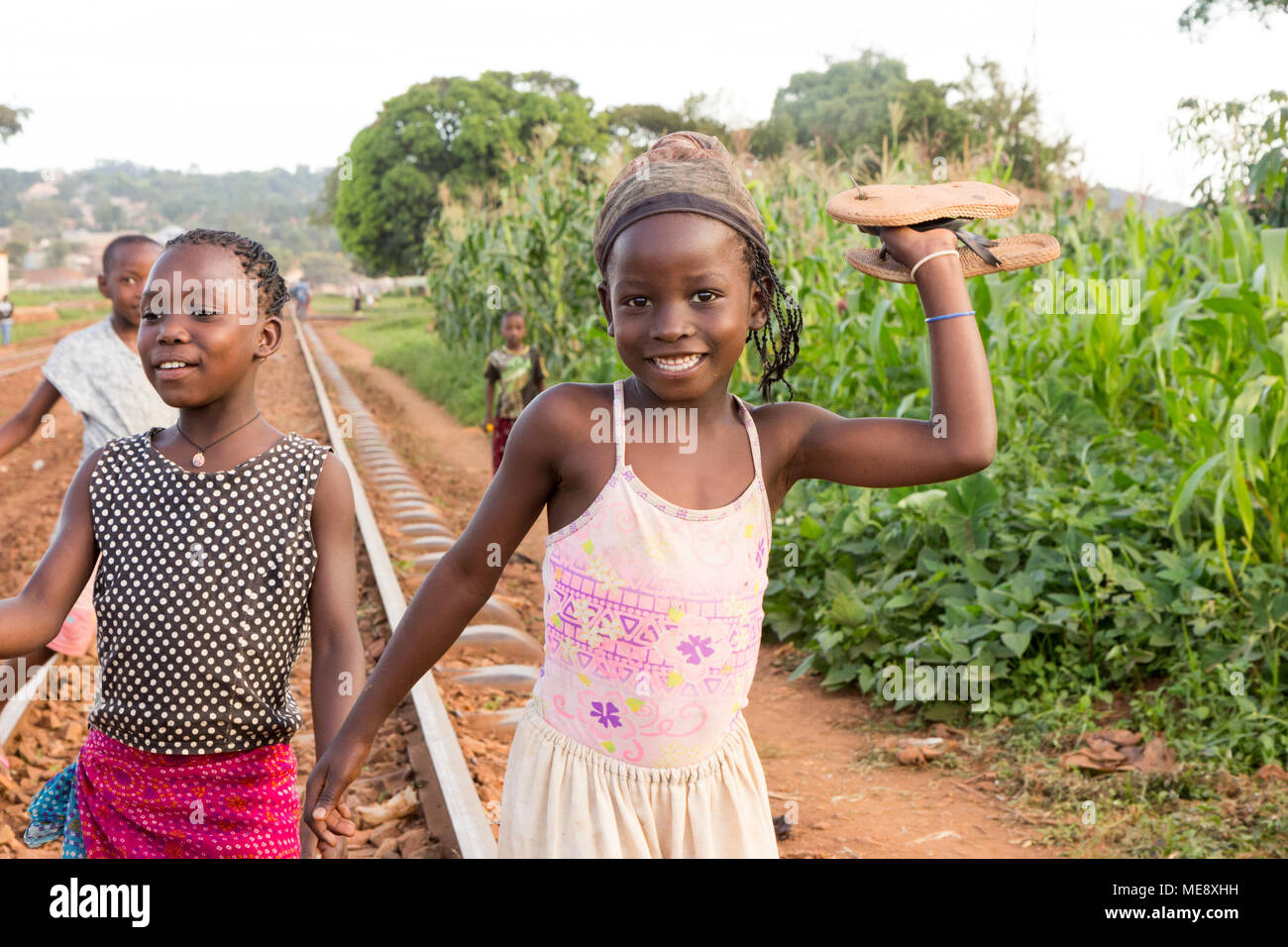 Smiling Ugandan girls on a railway track in a rural area in Uganda ...