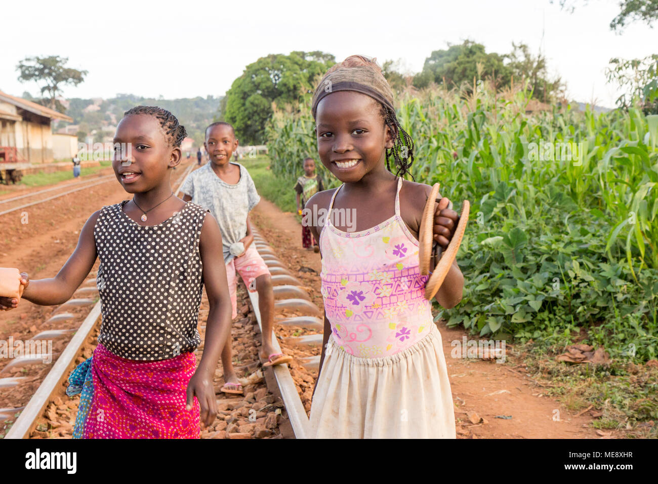 Smiling Ugandan girls on a railway track in a rural area in Uganda ...