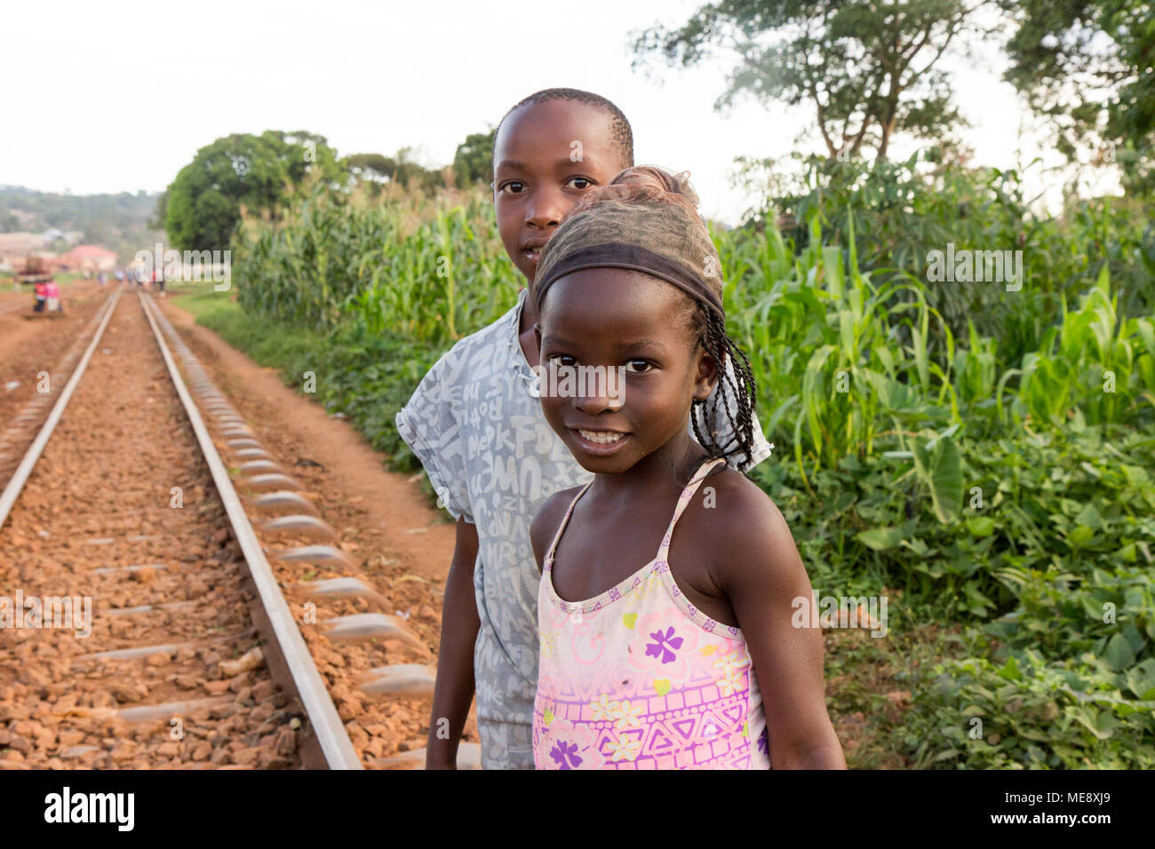Smiling Ugandan girls on a railway track in a rural area in Uganda ...