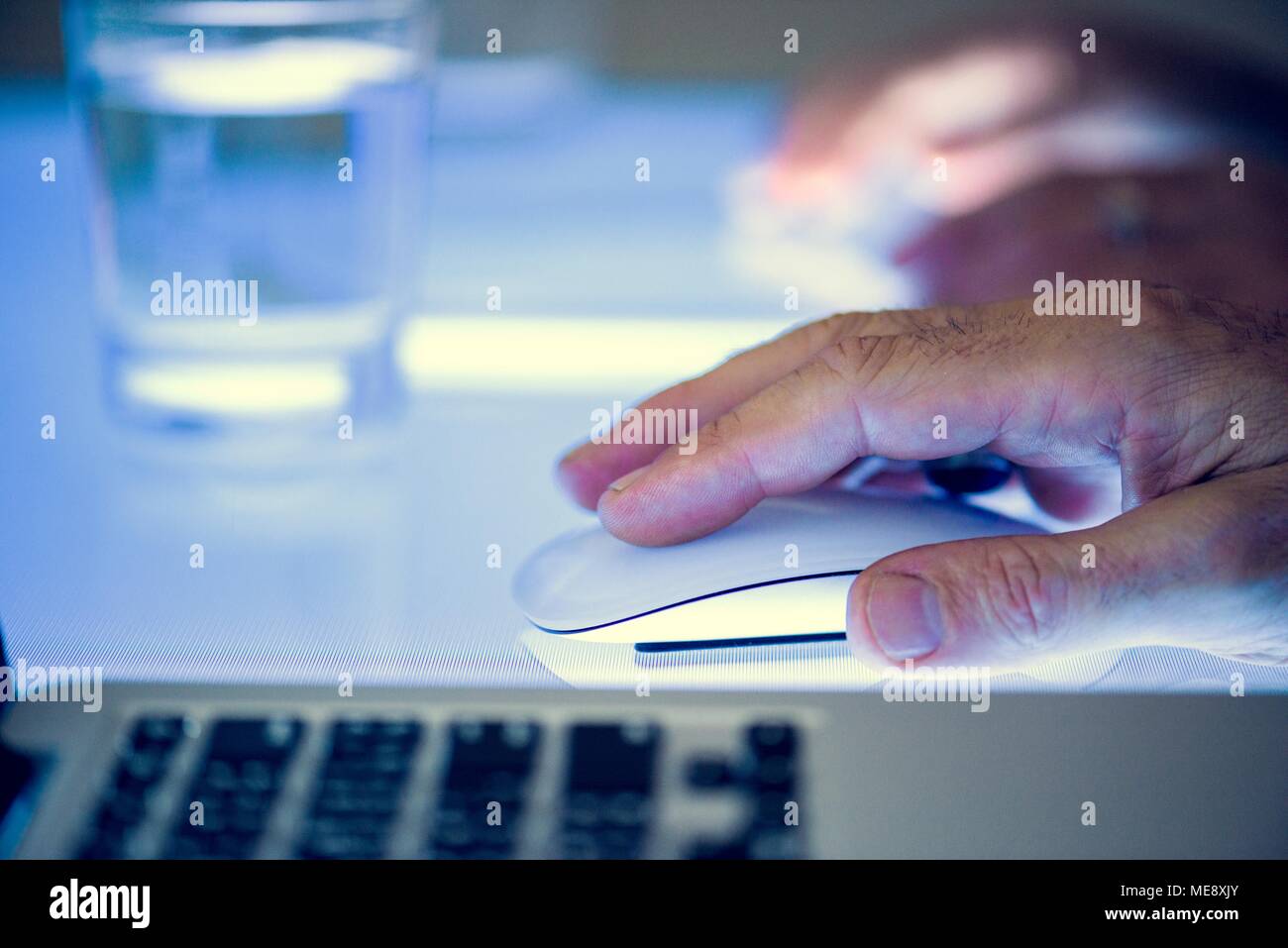 Hand holding using mouse clicking Stock Photo - Alamy