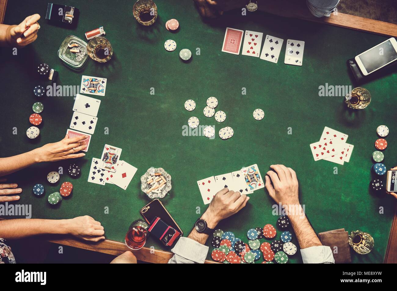 Group of people playing gambling together Stock Photo - Alamy