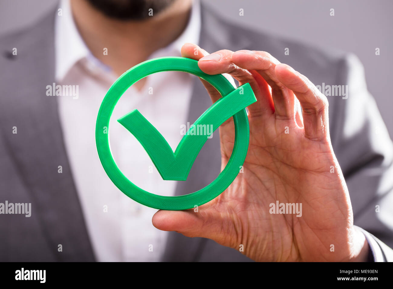 Close-up Of A Businessperson's Hand Holding Green Check Mark Icon Stock ...