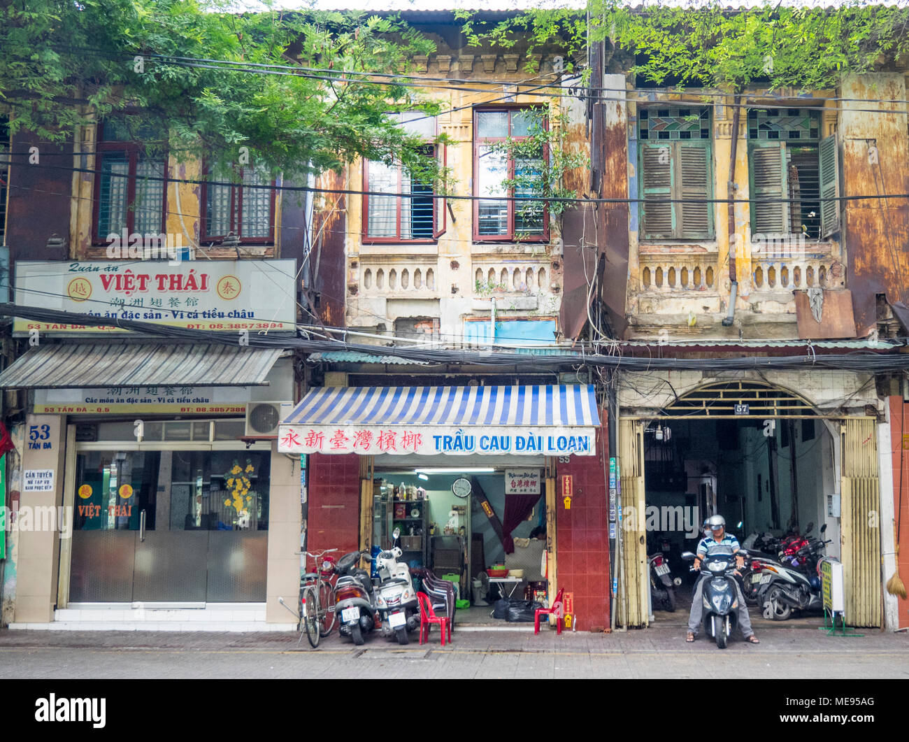 Rundown facade of a French colonial shophouse in Ho Chi Minh City ...