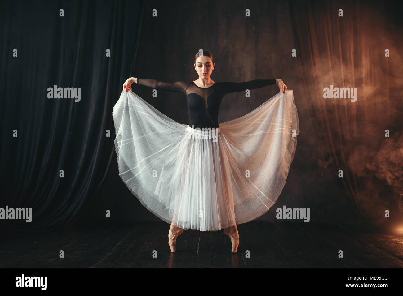 Classical ballet dancer in motion on the stage in theatre. Graceful ...
