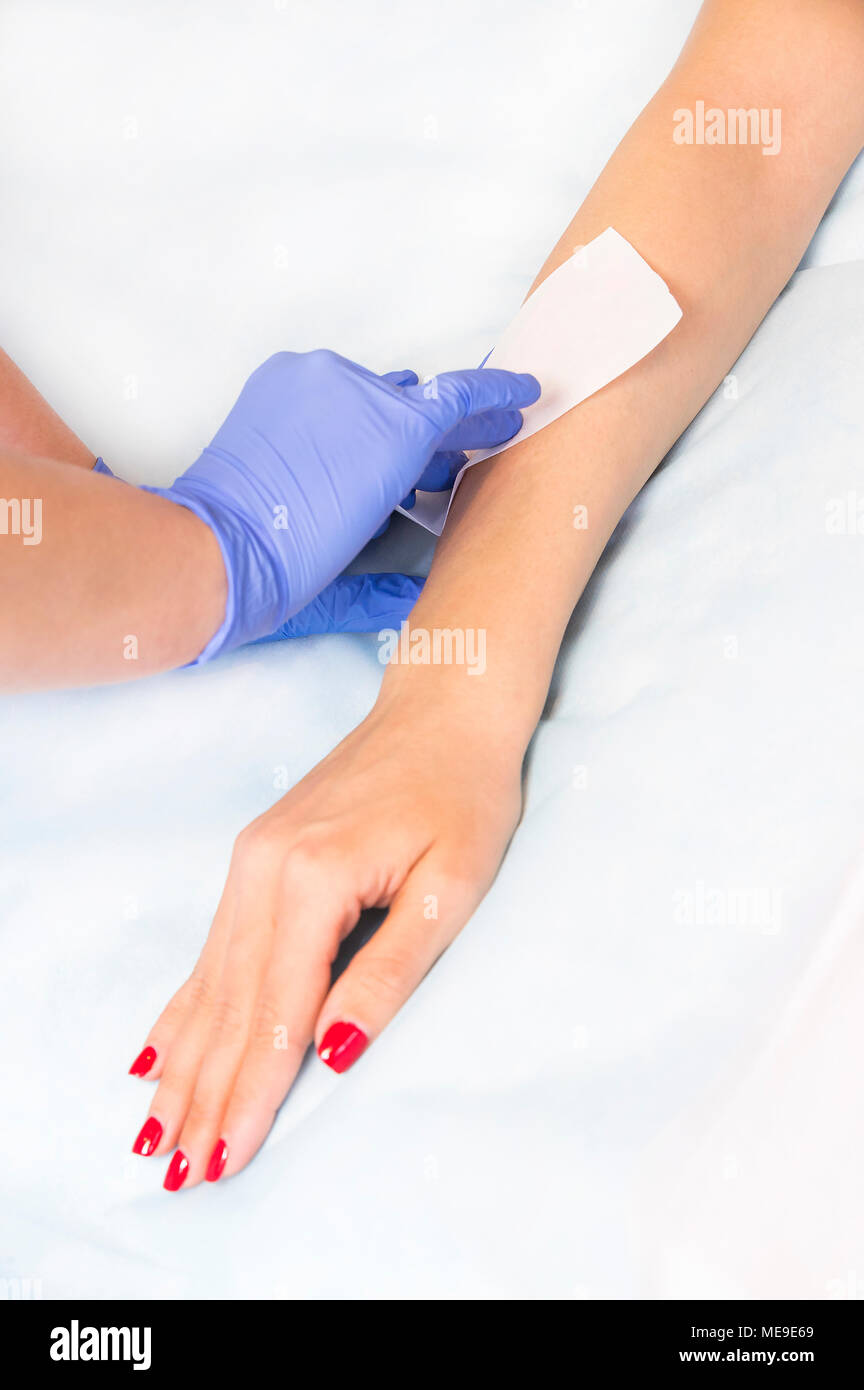 The process of classical wax depilation of female limbs in the beauty ...