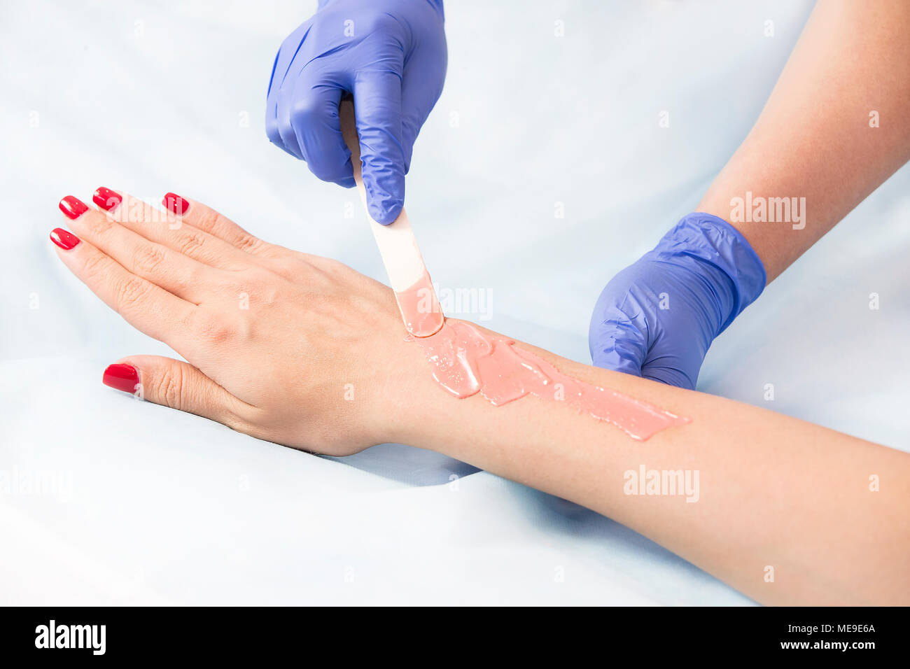The process of classical wax depilation of female limbs in the beauty ...