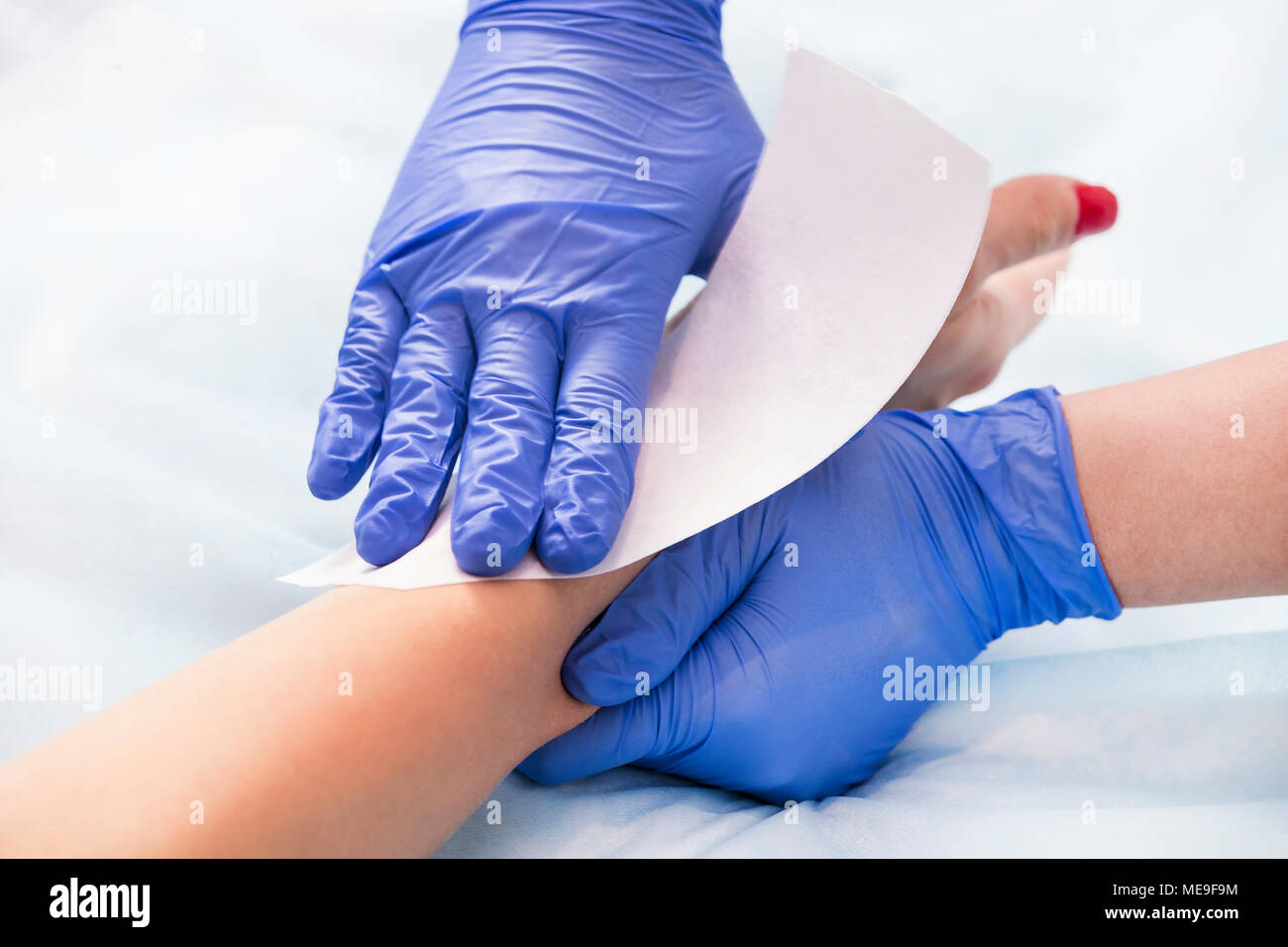The process of classical wax depilation of female limbs in the beauty ...