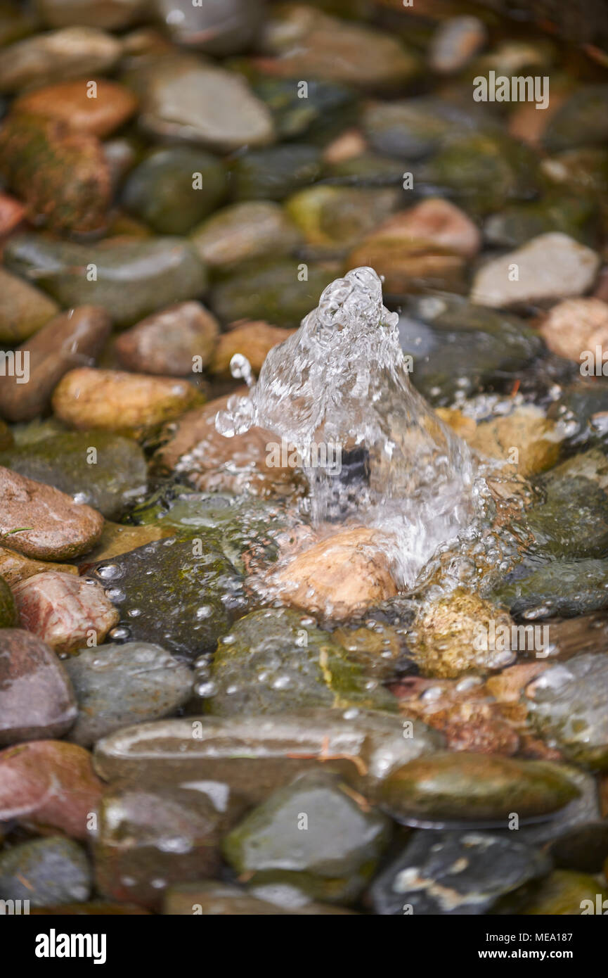 Water Fountain and wet pebbles Stock Photo - Alamy
