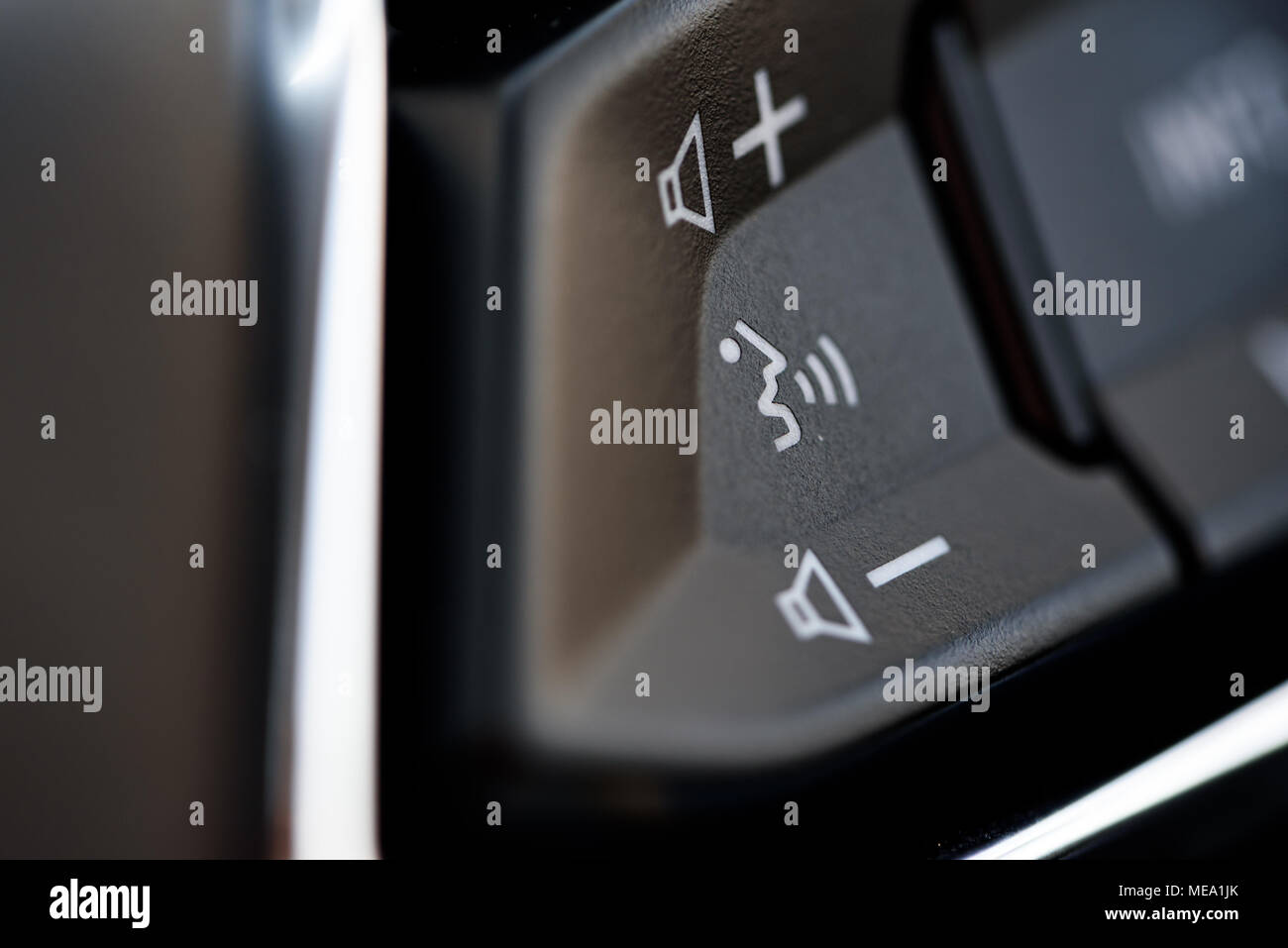 Modern car audio system control button on a steering wheel with voice ...