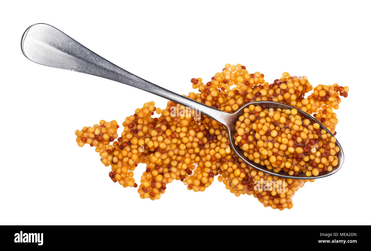 French mustard. Splashes and spilled mustard seeds sauce with spoon ...