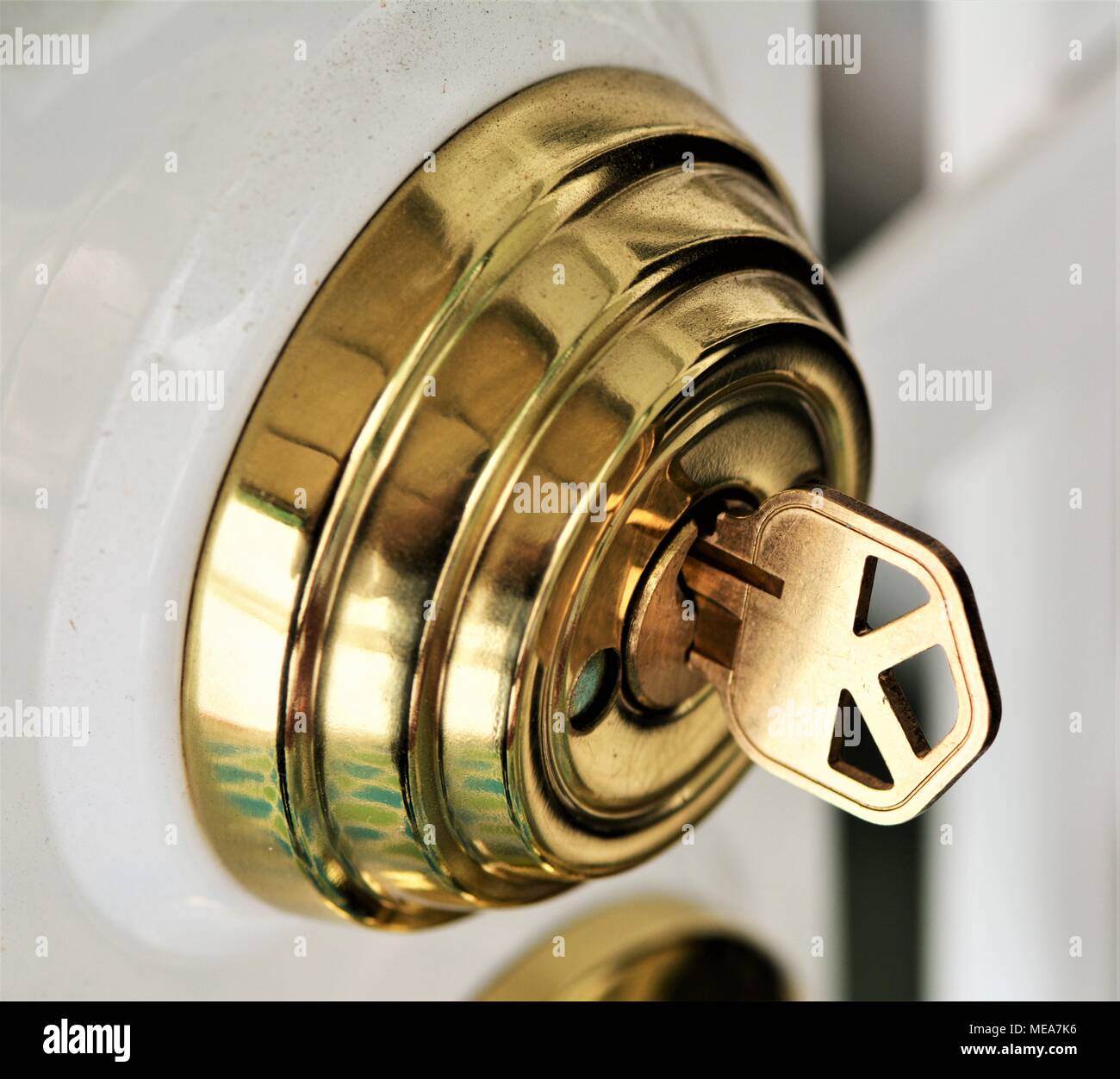 Key in a Door Lock Stock Photo - Alamy
