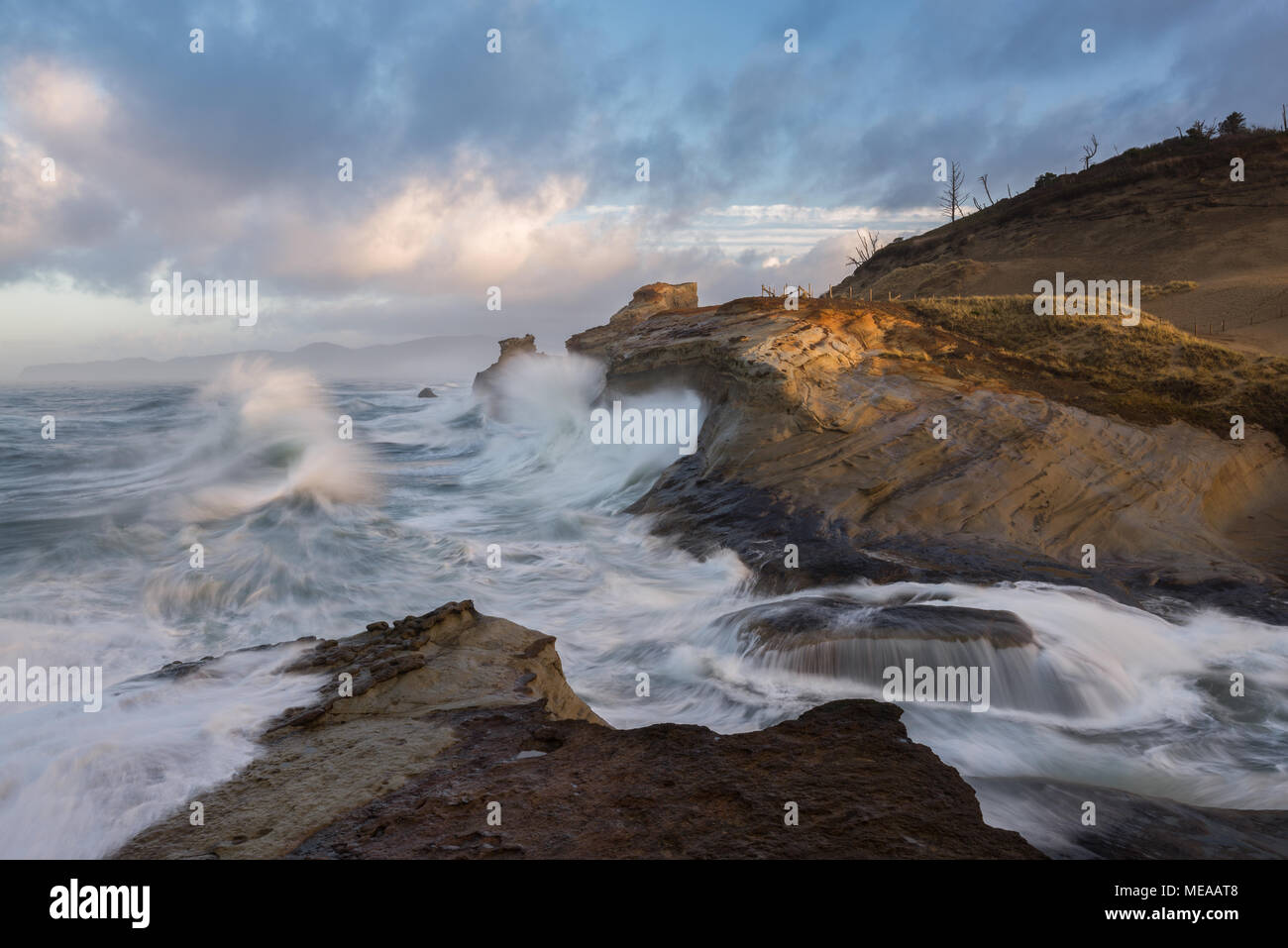 Waves crashing into the sandstone cliffs at Cape Kiwanda - Pacific City ...
