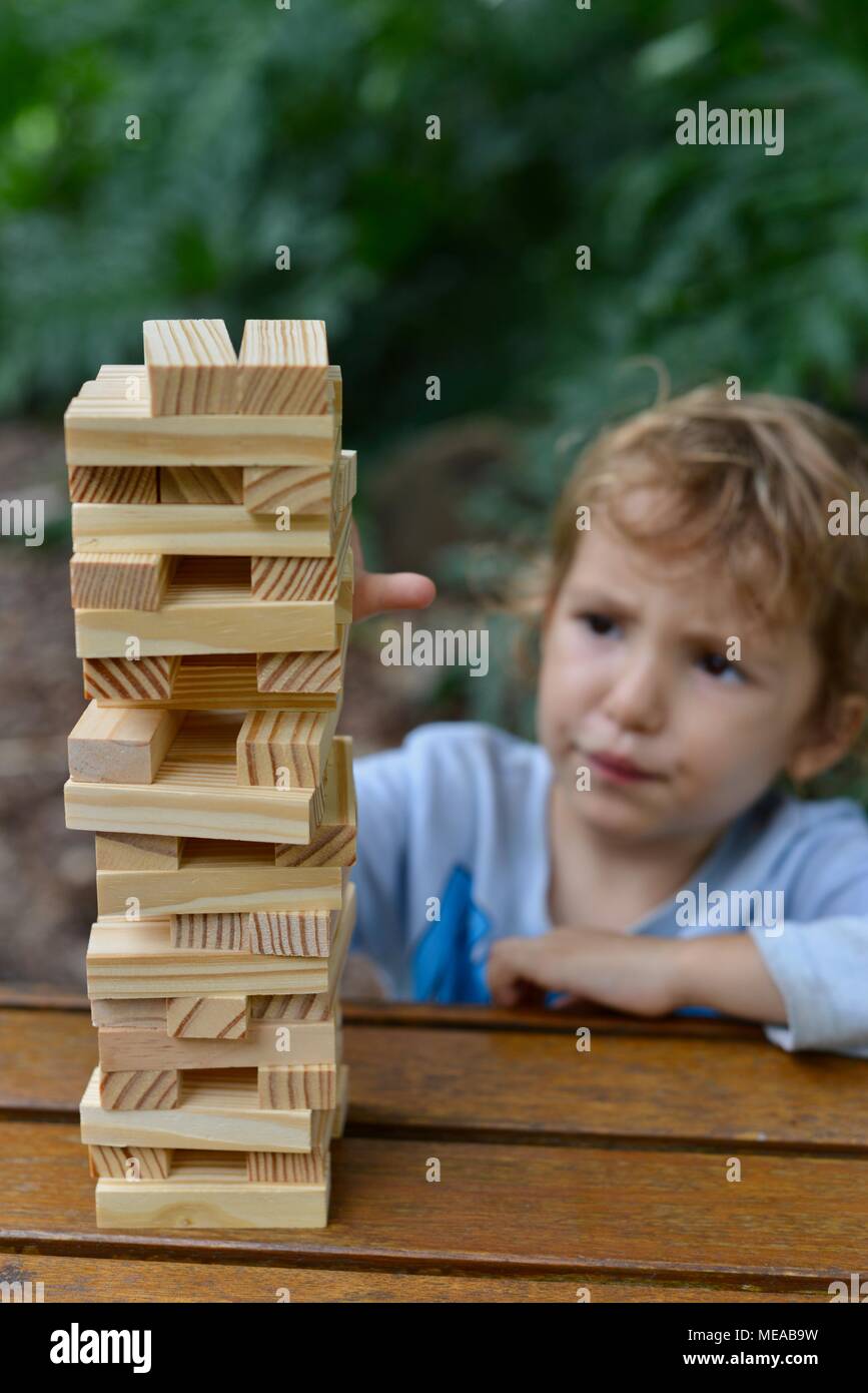 Cute child playing with building blocks and developing fine motor ...