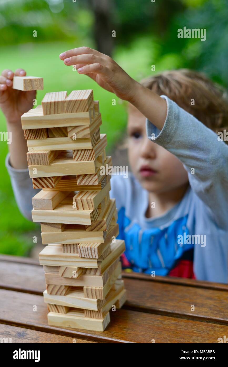 Cute child playing with building blocks and developing fine motor ...
