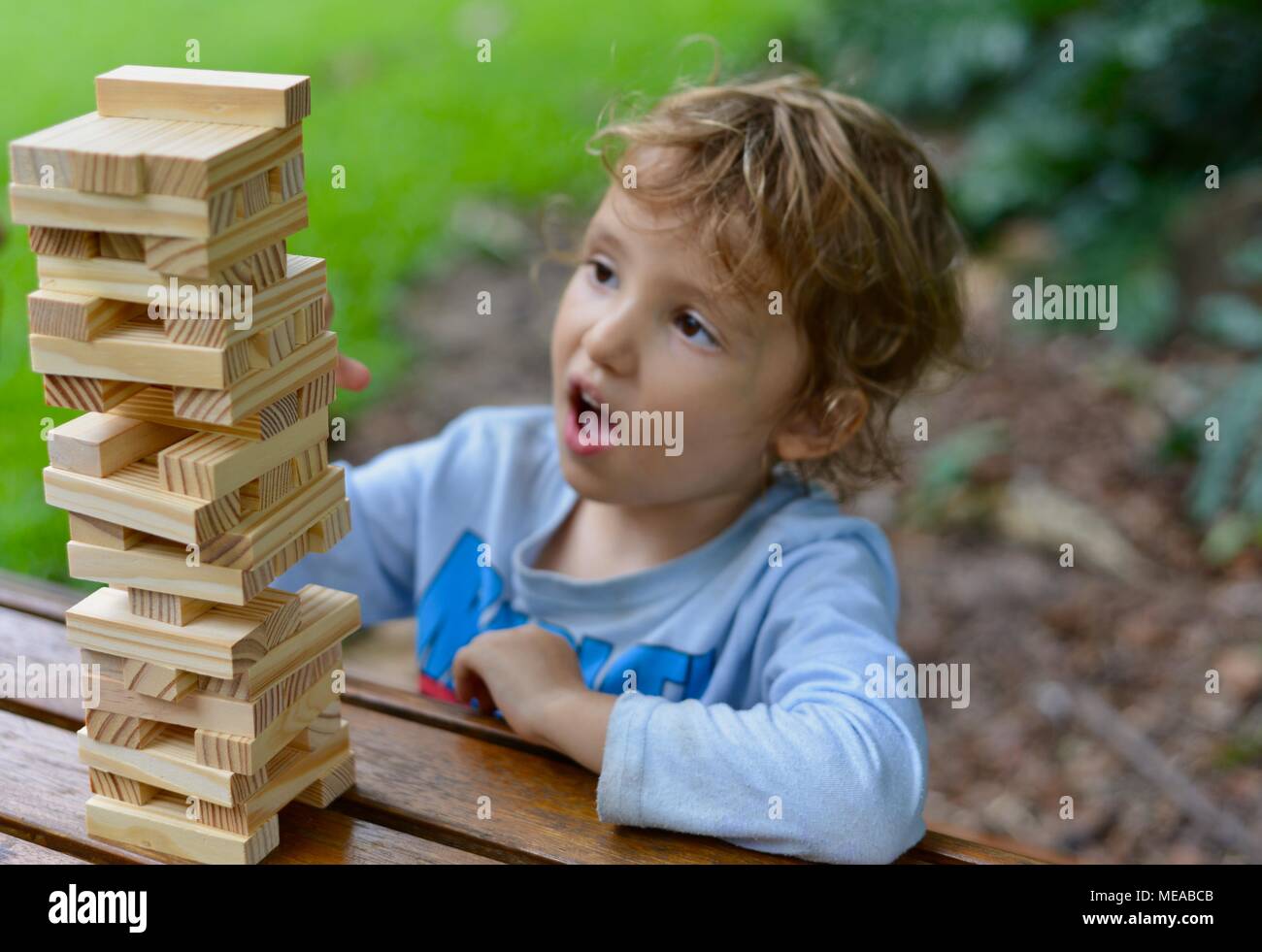 Cute child playing with building blocks and developing fine motor ...