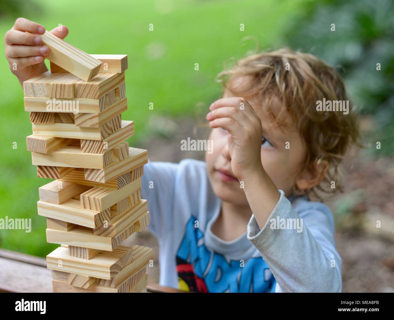 Cute child playing with building blocks and developing fine motor ...