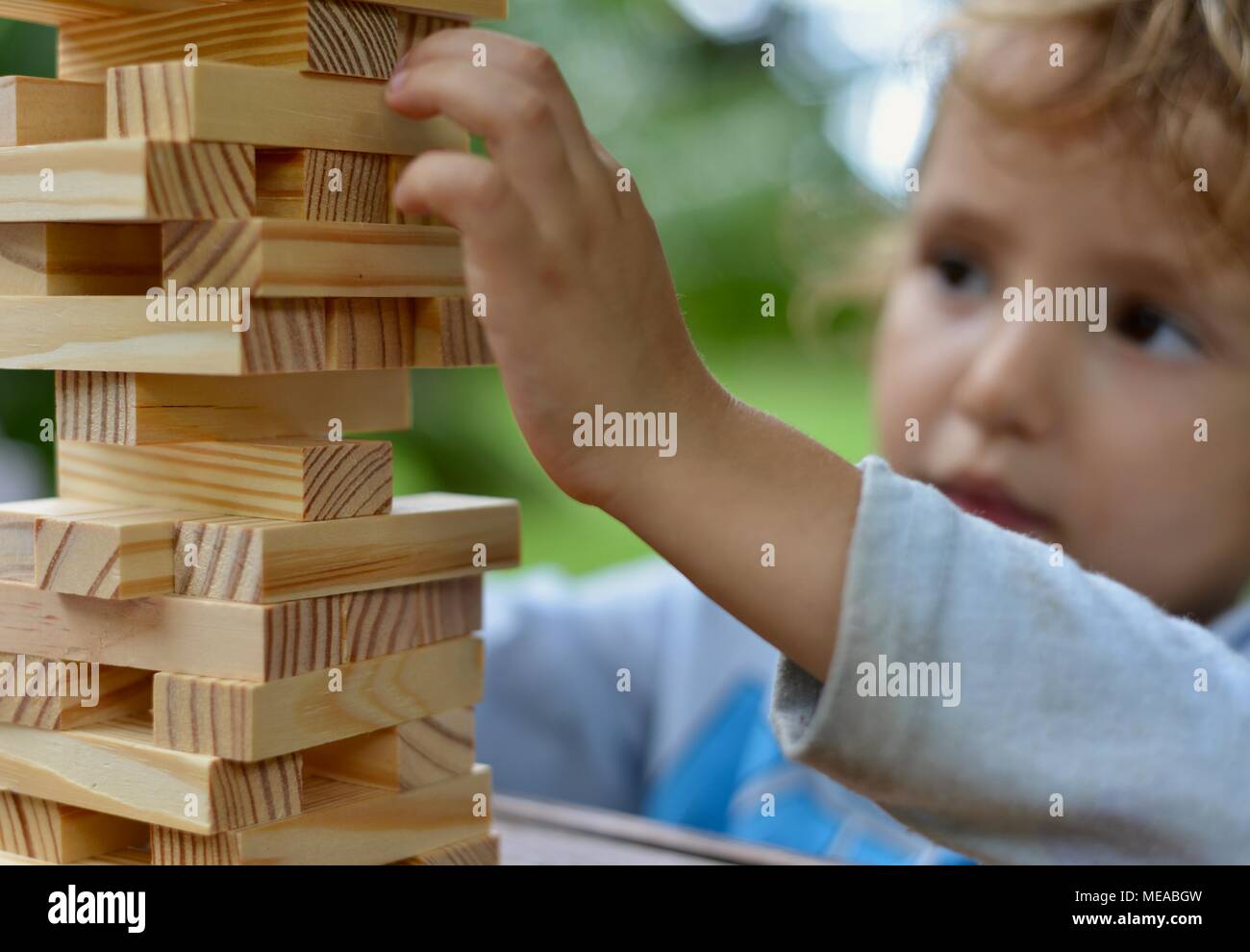 Cute child playing with building blocks and developing fine motor ...